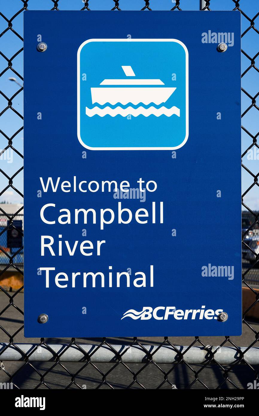 A vivid blue and white sign with a symbol for a ferry stating Welcome ...