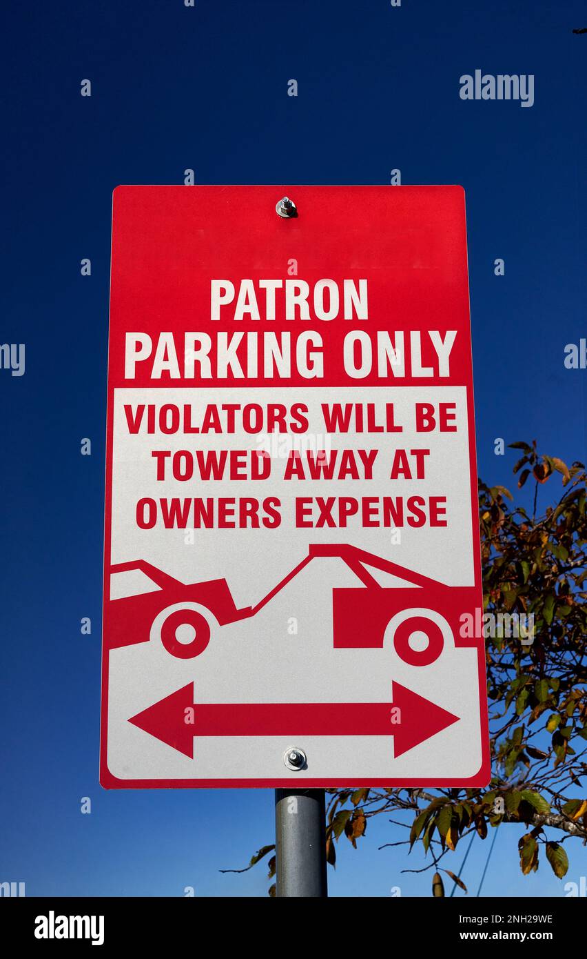 A red and white traffic sign showing a tow truck towing a car and ...