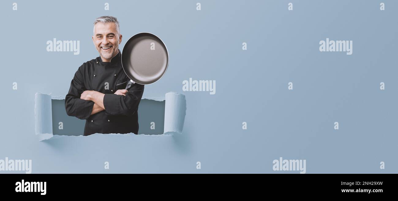 Confident smiling successful chef posing with arms crossed, he is ...