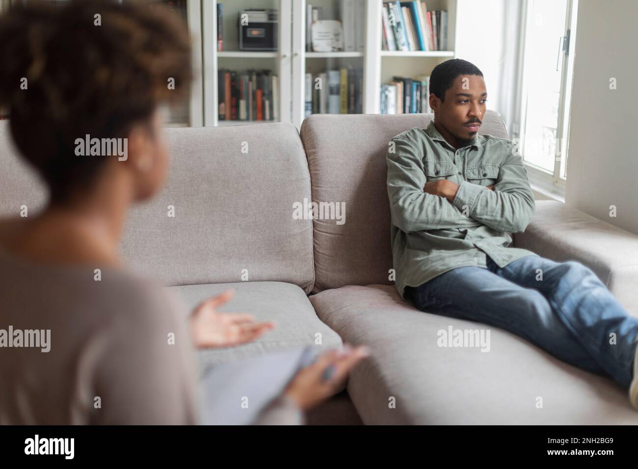 Reserved angry young black man attending psychotherapist Stock Photo ...