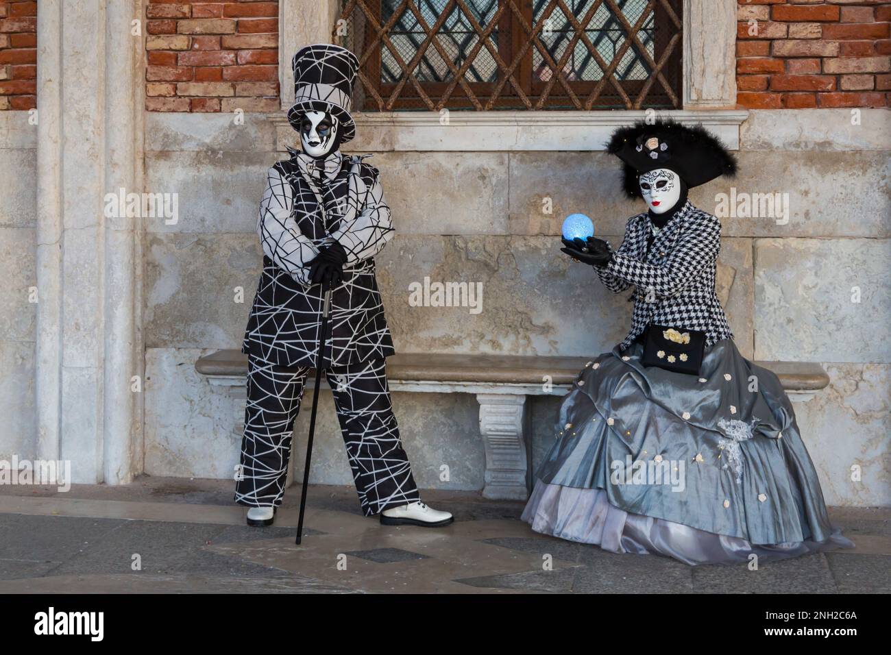 Carnival goers dressed in splendid costumes and masks during Venice ...