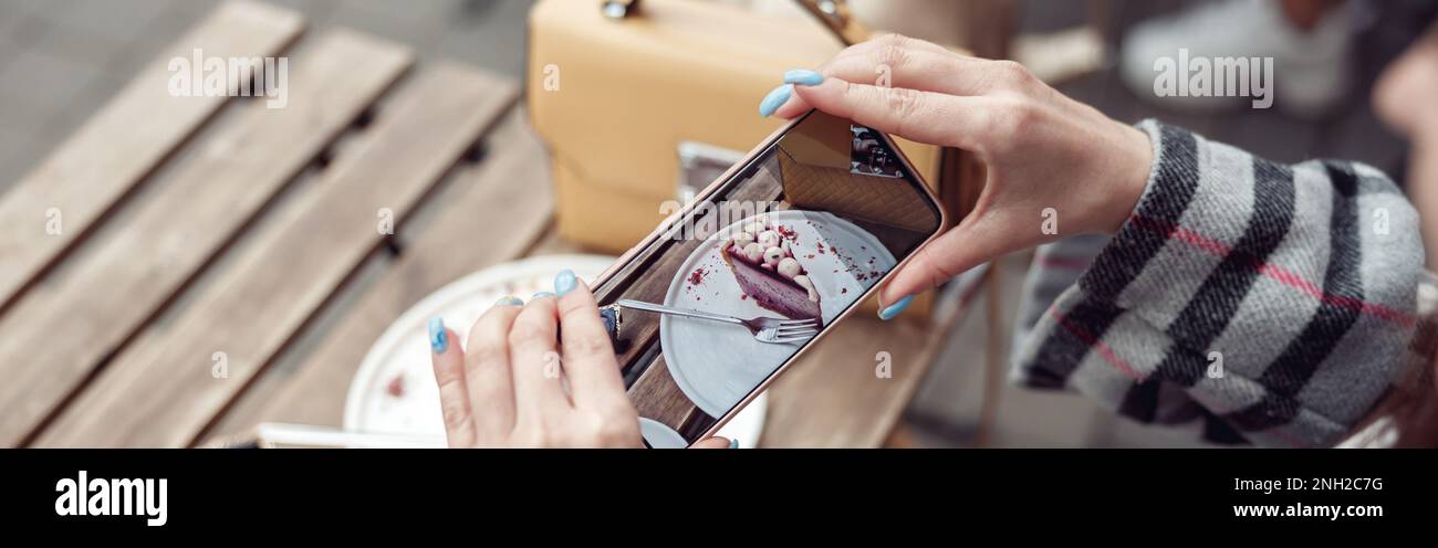 View over shoulder on woman taking photo with smartphone of coffee and ...
