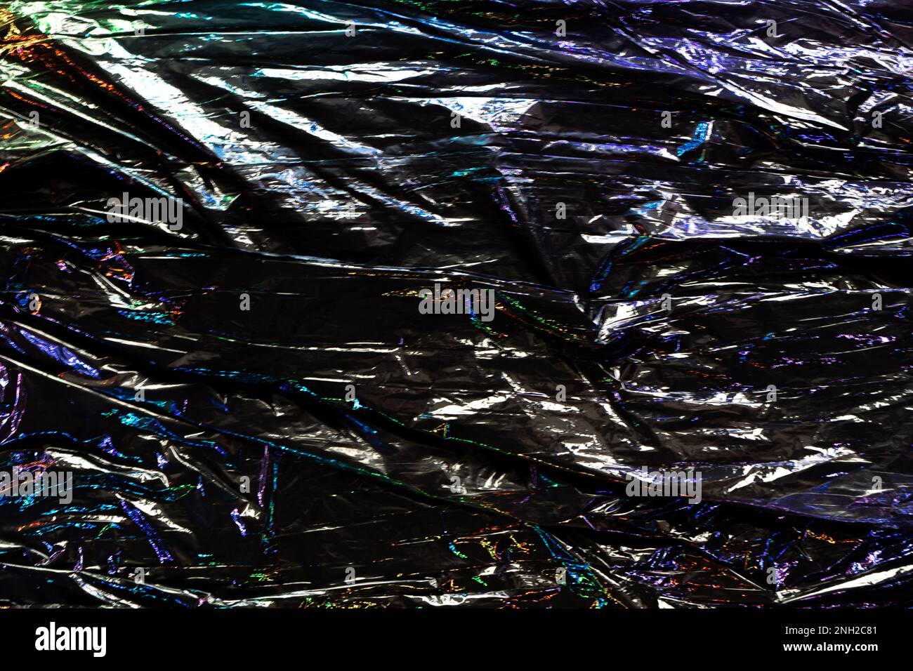 Black color plastic wrap background. Dark crumpled wrinkled plastic ...