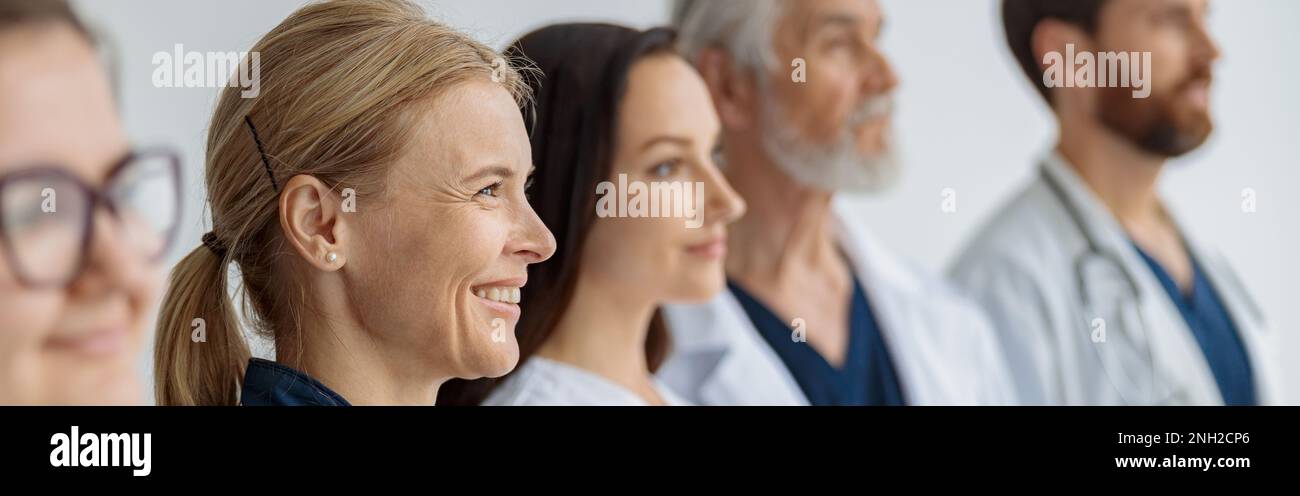 Group of professional doctors standing in a line at the modern clinic ...