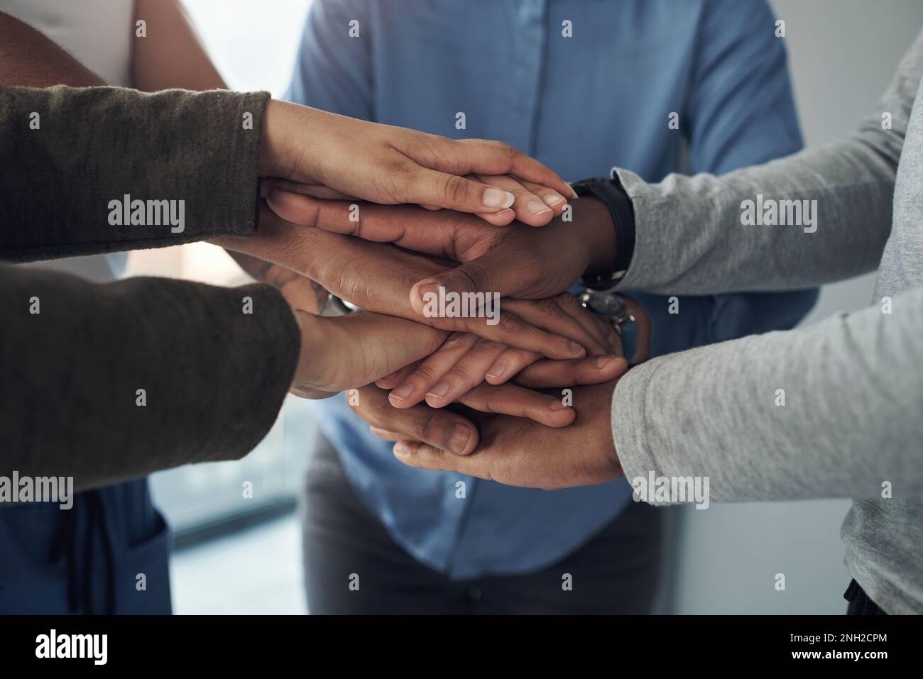 Together we can. a group of unrecognizable people stacking their hands ...