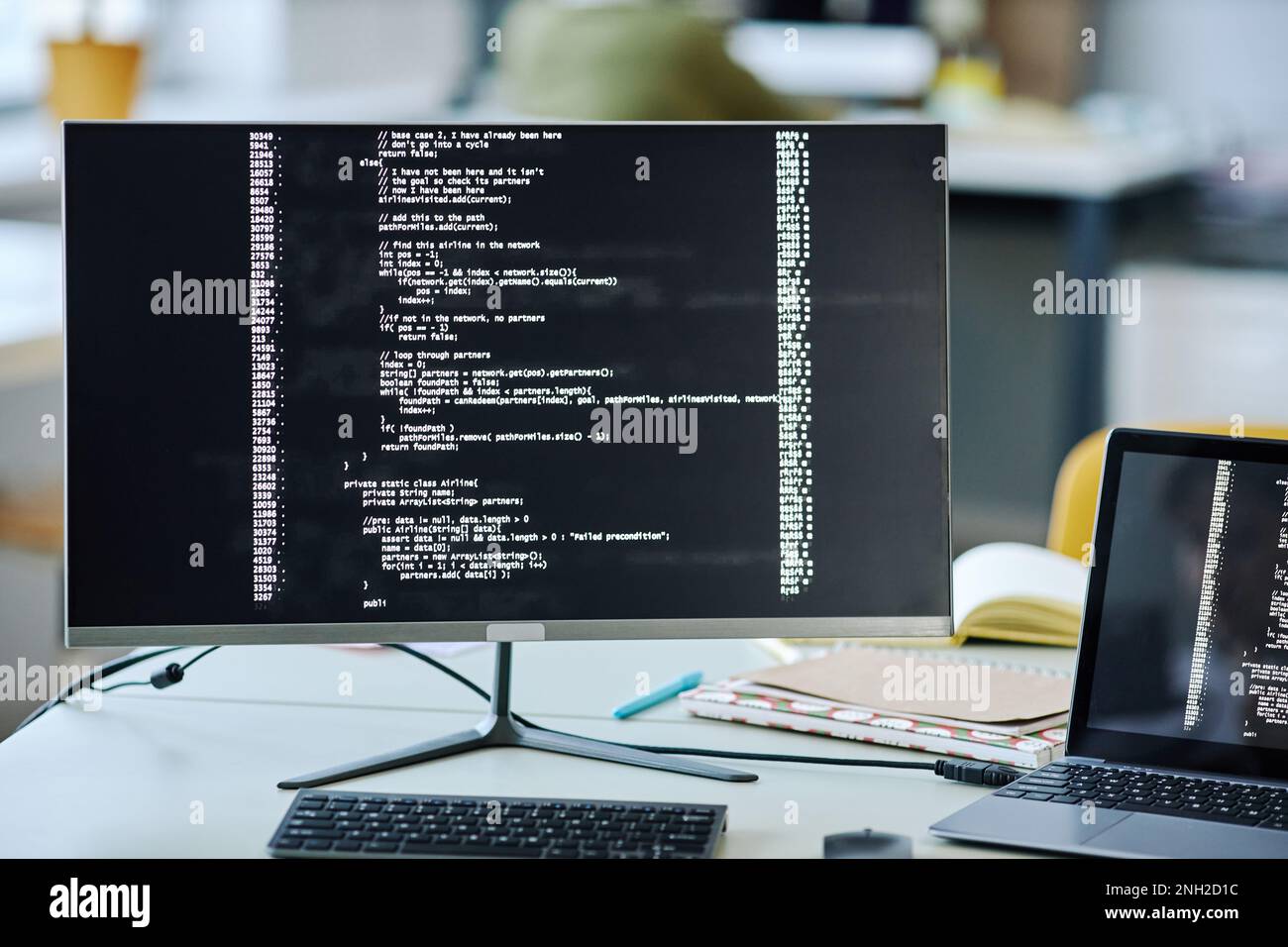 Front view background image of computer screen with code lines on desk ...