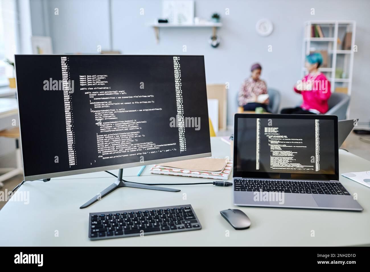 Background image of computer screens with code lines on desk in ...
