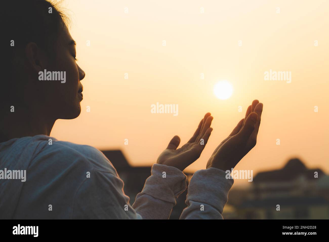 Woman praying in the morning on the sunrise background. Christianity ...