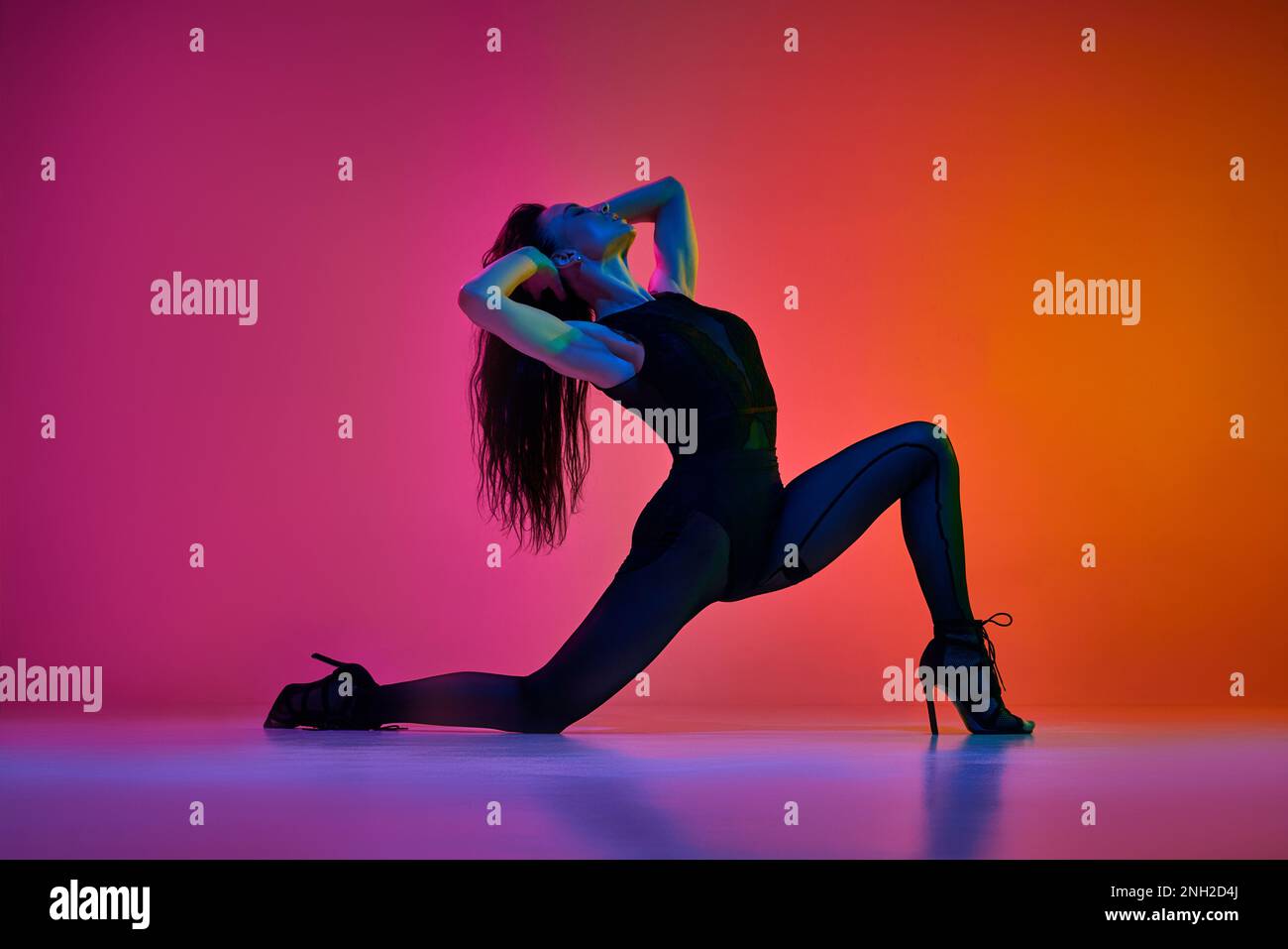 Flexibility and passion. Young woman dancing high heel, contemp dance ...