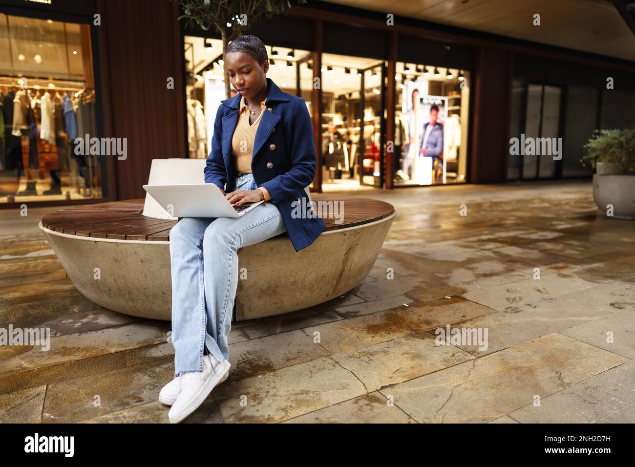 African female student working on computer in public place Stock Photo ...