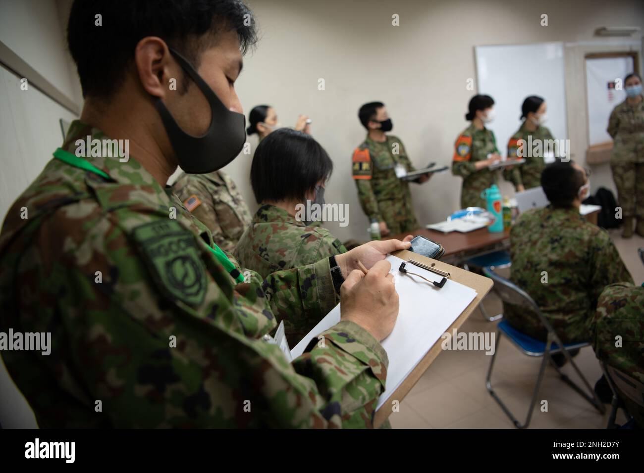 A Japan Ground Self-Defense Force member takes notes at triage training ...