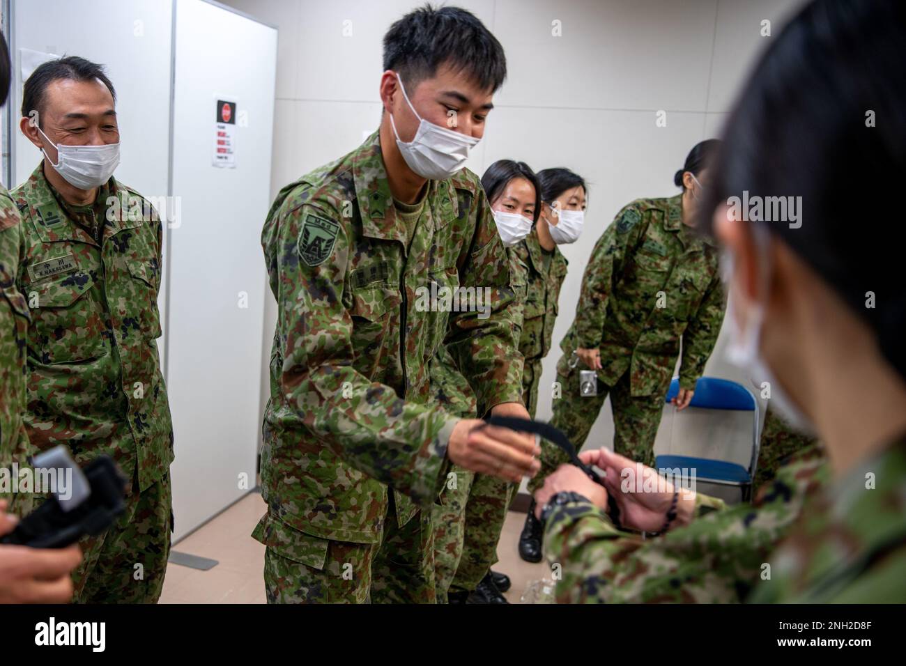 A Japan Ground Self-Defense Force member uses a tourniquet for triage ...
