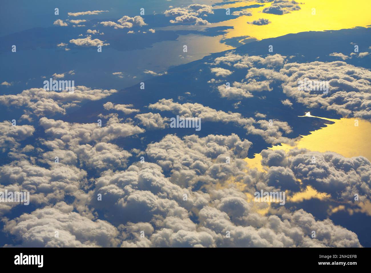Flight over clouds and water bay . Sea and islands view from the sky ...