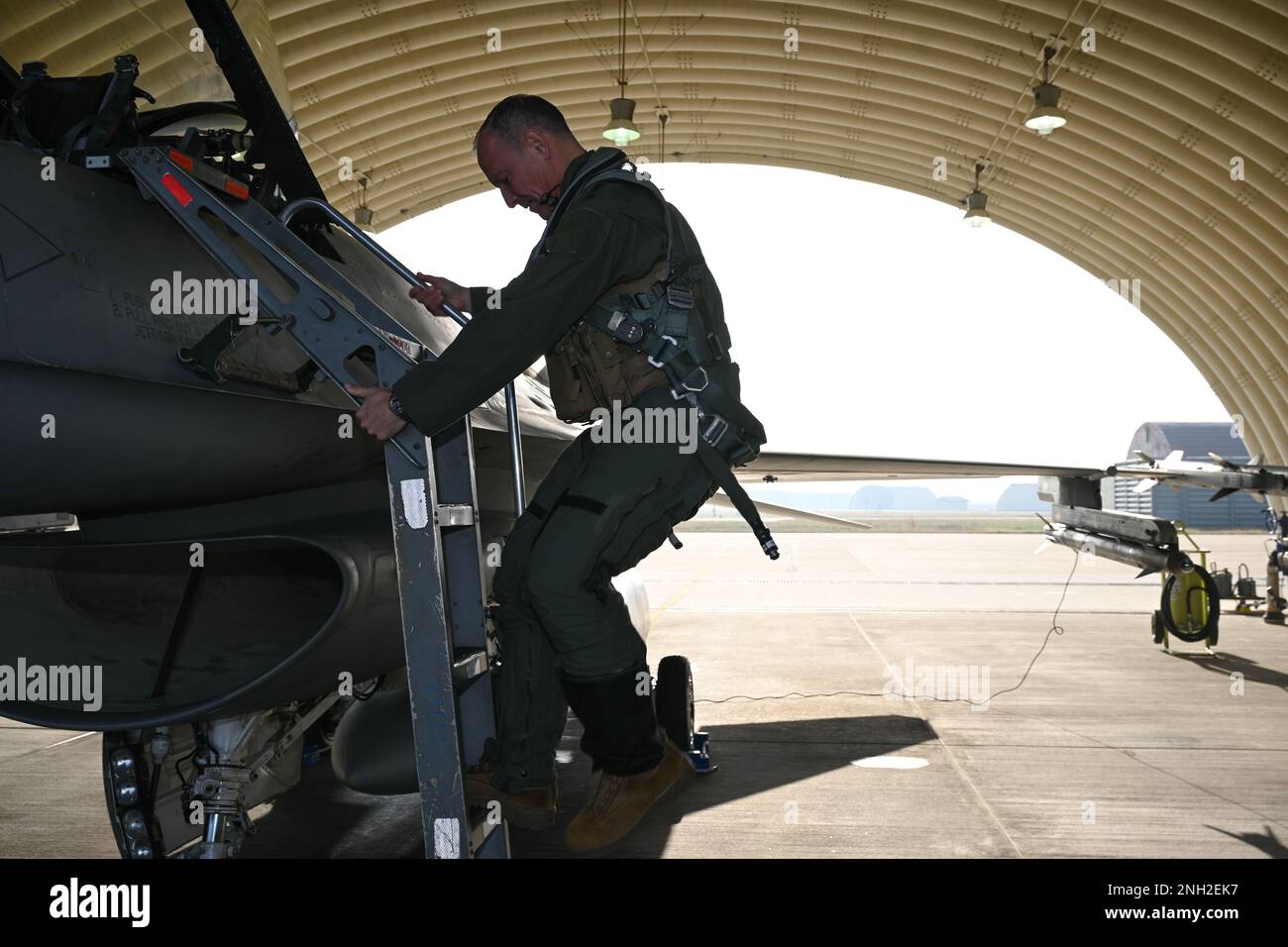 Lt. Gen. Scott L. Pleus, 7th Air Force commander, climbs up an F-16 ...