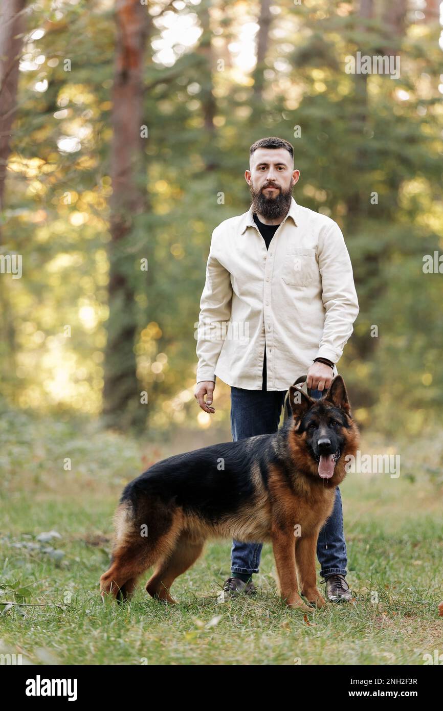 Man holding dog german shepherd hi-res stock photography and images - Alamy