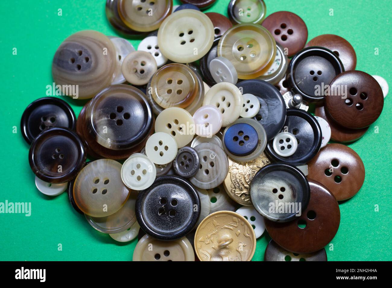 a large number of buttons for clothes in a heap Stock Photo - Alamy