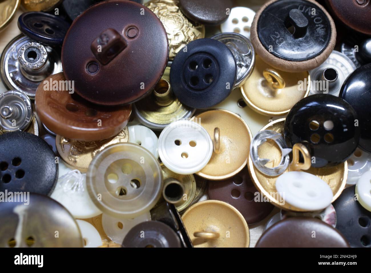 a large number of buttons for clothes in a heap Stock Photo - Alamy