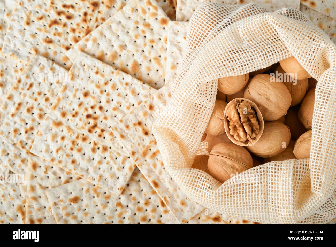 Passover celebration concept. Organic walnuts in eco bags on matzah ...