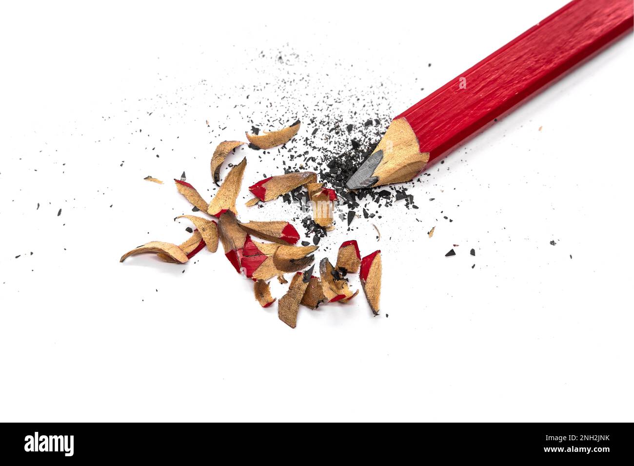 Red wooden carpenter's pencil sharpened with knife. Close up with ...