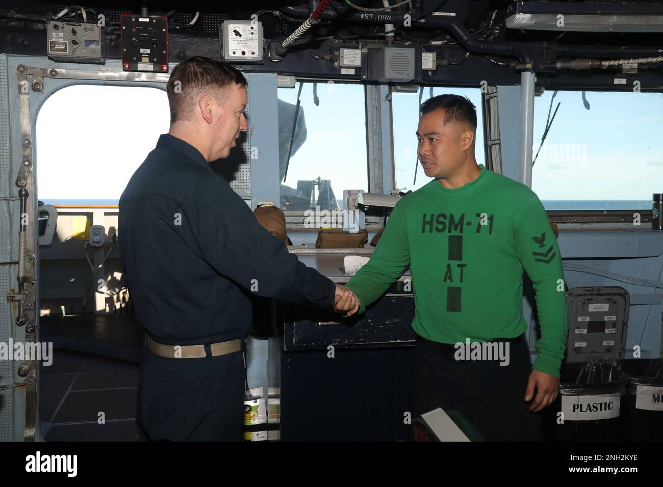 Rear Adm. Kevin Lenox, left, commander, Carrier Strike Group (CSG) 3 ...