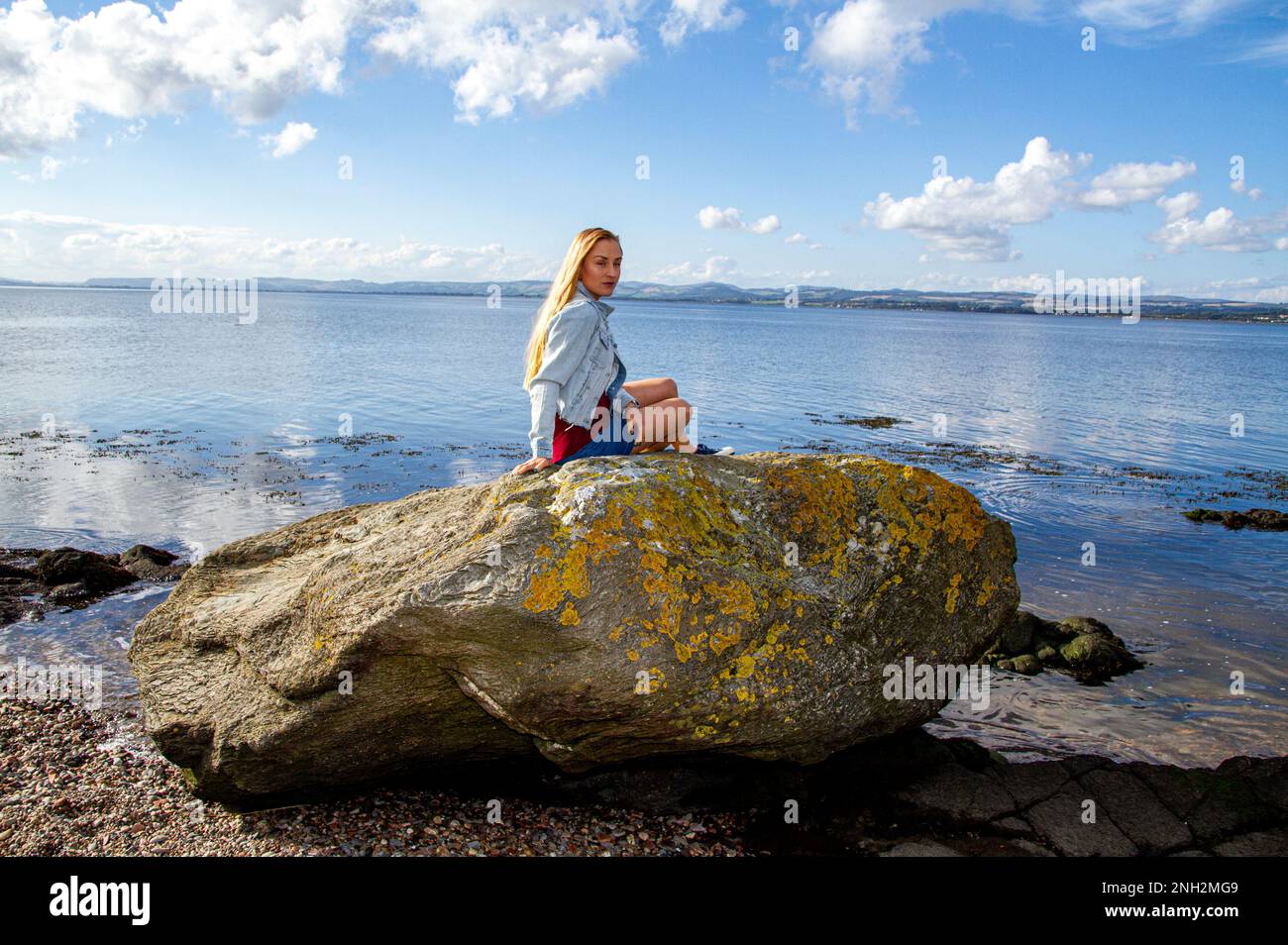 Woman wearing short skirt sitting hi-res stock photography and images ...