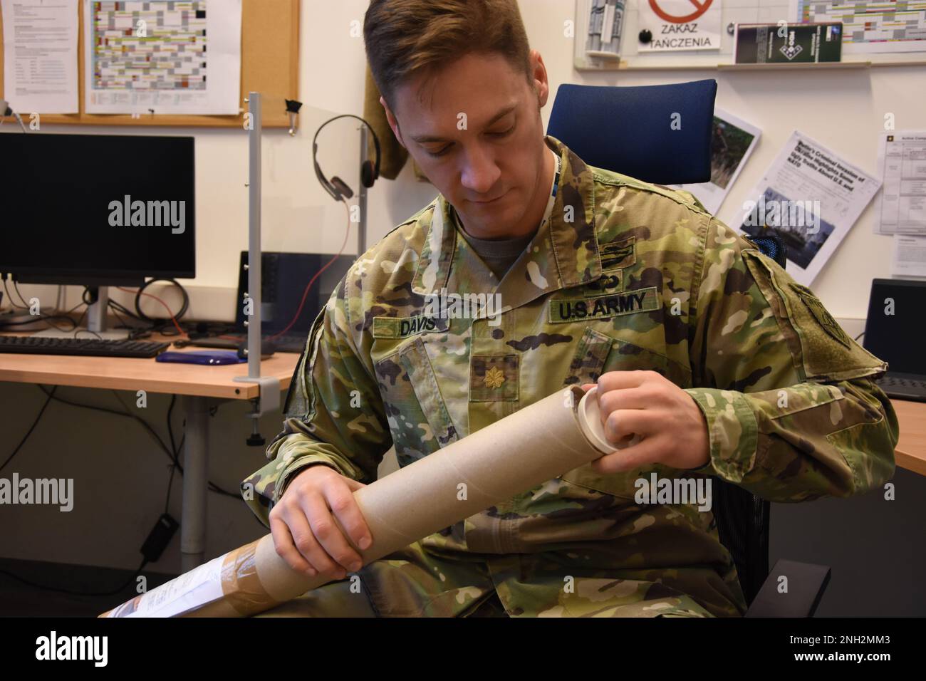 Maj. Joseph Davis, JFTC Media Division, opens a package during Exercise ...