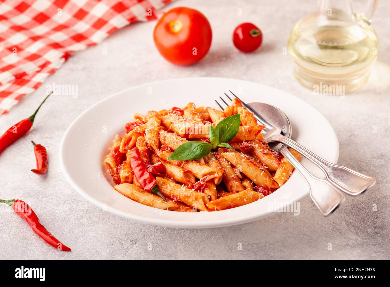 Classic italian pasta penne alla arrabiata with fresh basil on a light ...