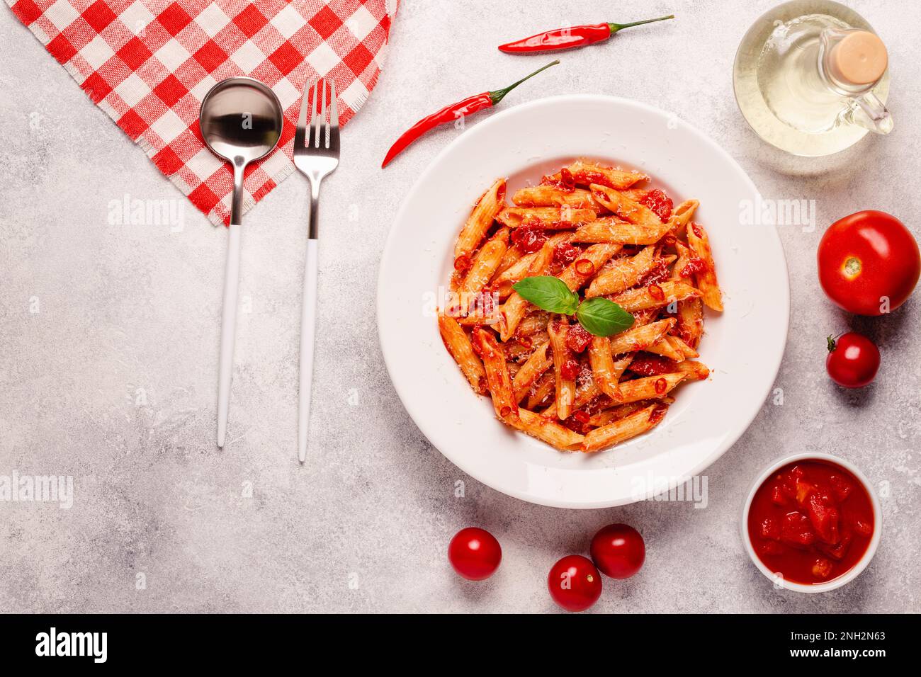 Classic italian pasta penne alla arrabiata with fresh basil on a light ...