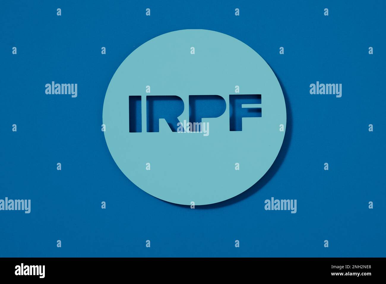 a round blue paper sign with the spanish acronym text for Impuesto ...