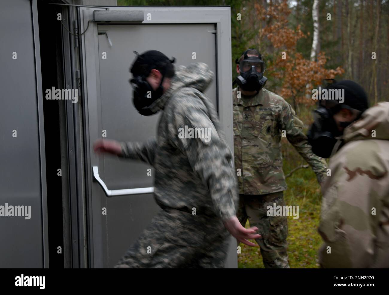 U.S. Soldiers rush into the gas chamber during the 7th Army Training ...