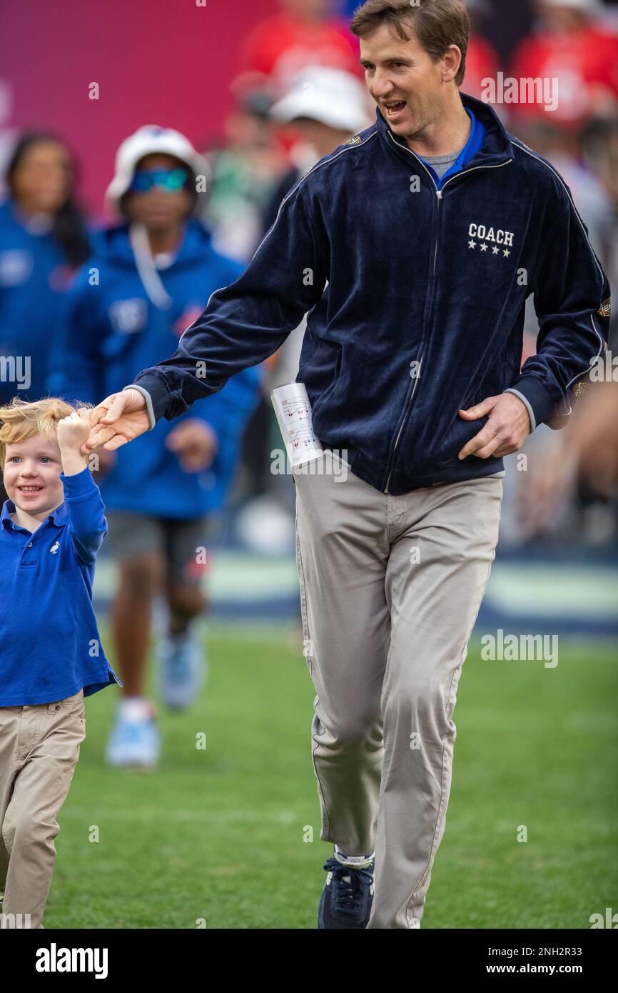 NFC head coach Eli Manning runs onto the field with his son Charles Manning during the NFL Pro ...