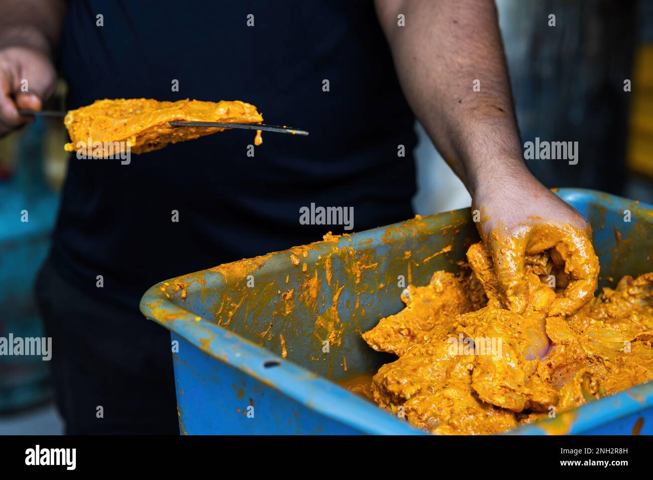 Prepping the chicken skew Kebab barbeque with marinated spices ...