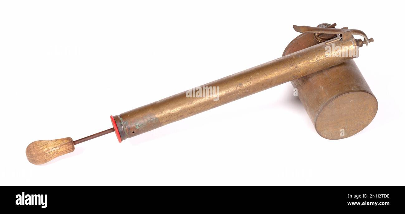 Old brass insecticide spray on a white background Stock Photo - Alamy