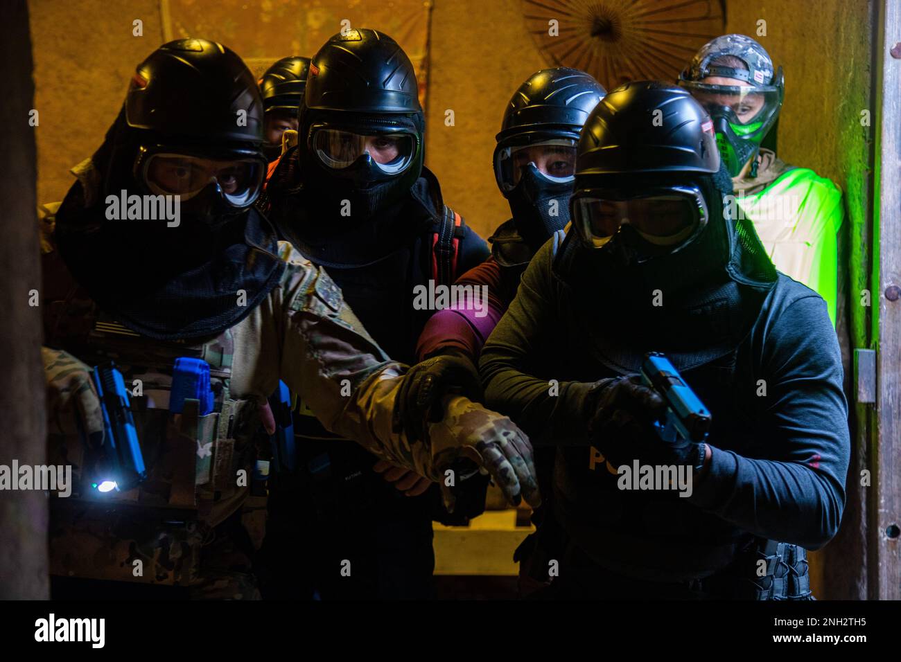 Officers with Honolulu Police Department strategize before entering an ...