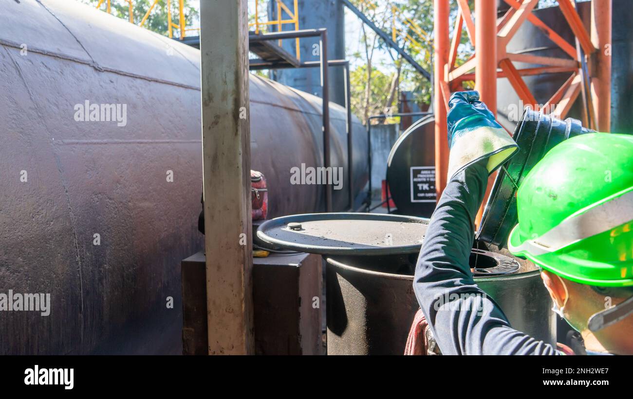 Worker recycling oil at a treatment plant Stock Photo - Alamy