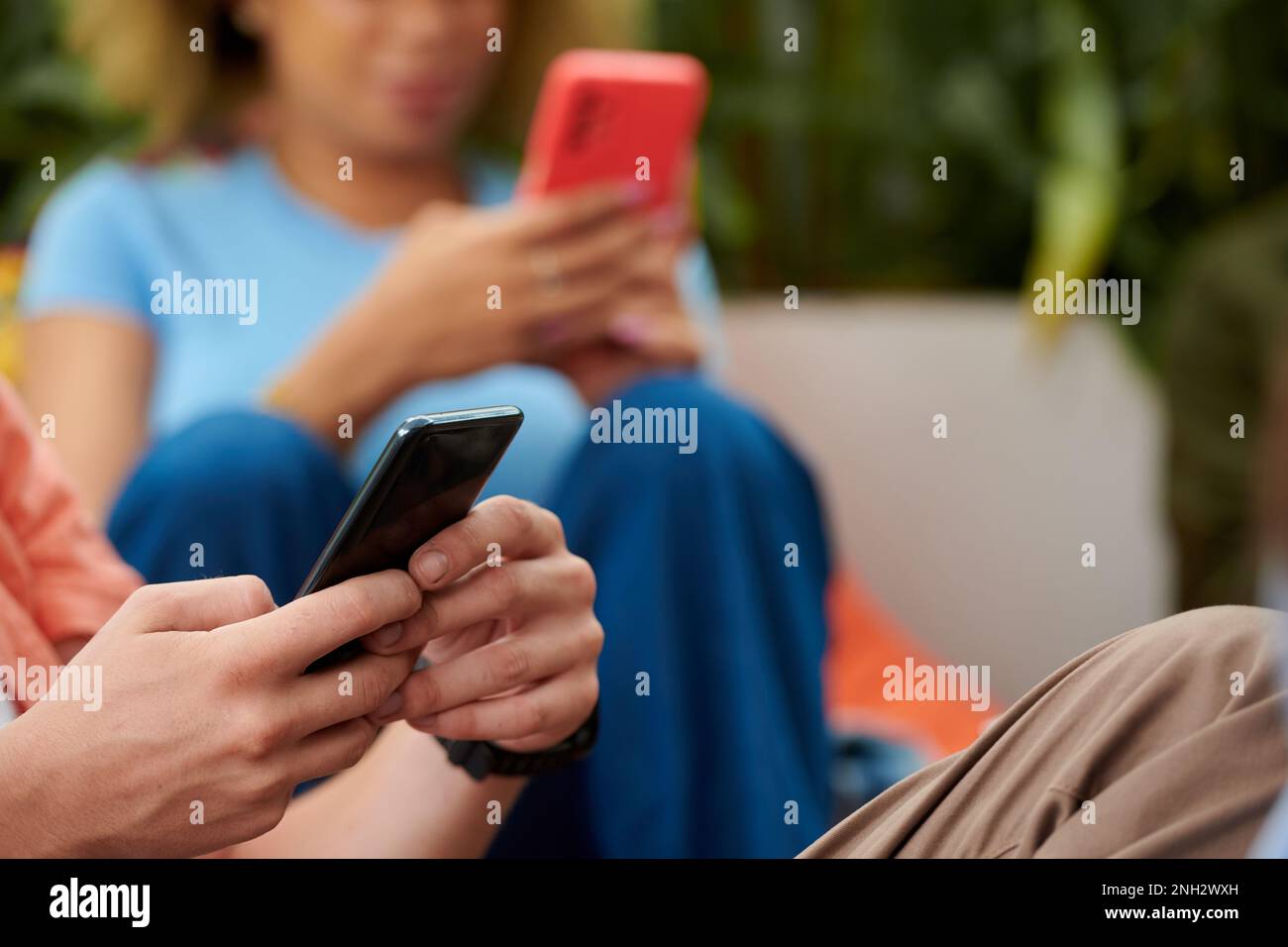 Young people texting friends instead of talking to each other Stock ...