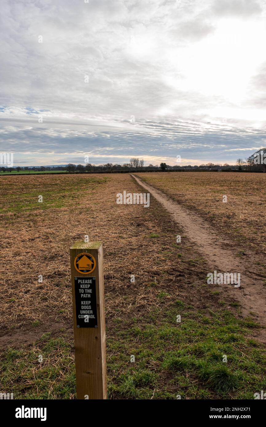 Public footpath across a farmers field with dogs warning and request to ...