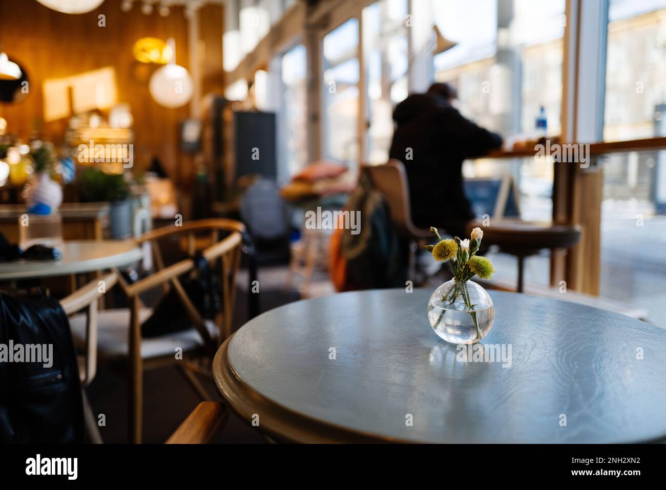 Indoor restaurant setup with a dish and glasses on the wooden table ...
