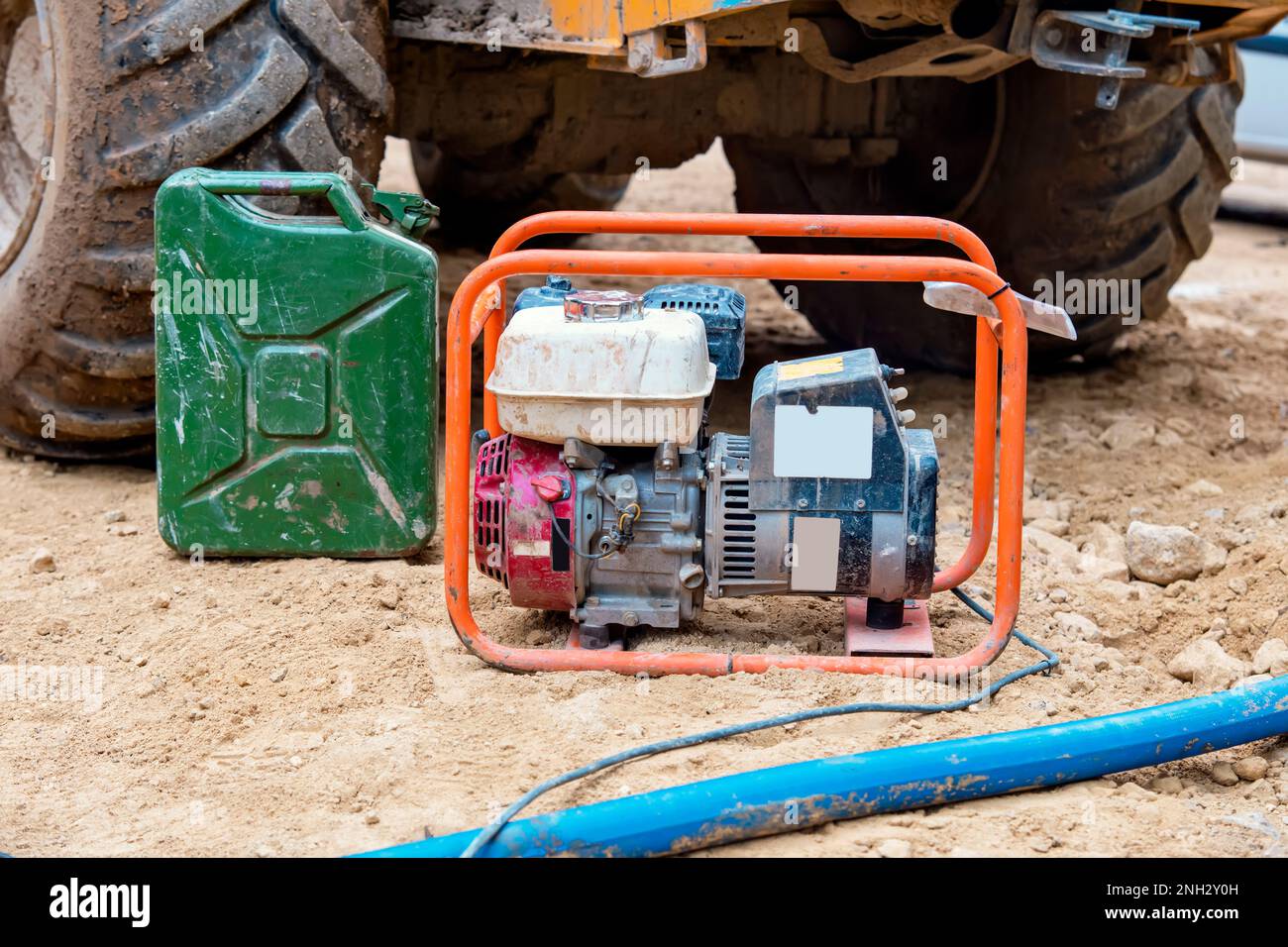 Mobile petrol power generator and jerry can with petrol on the building ...