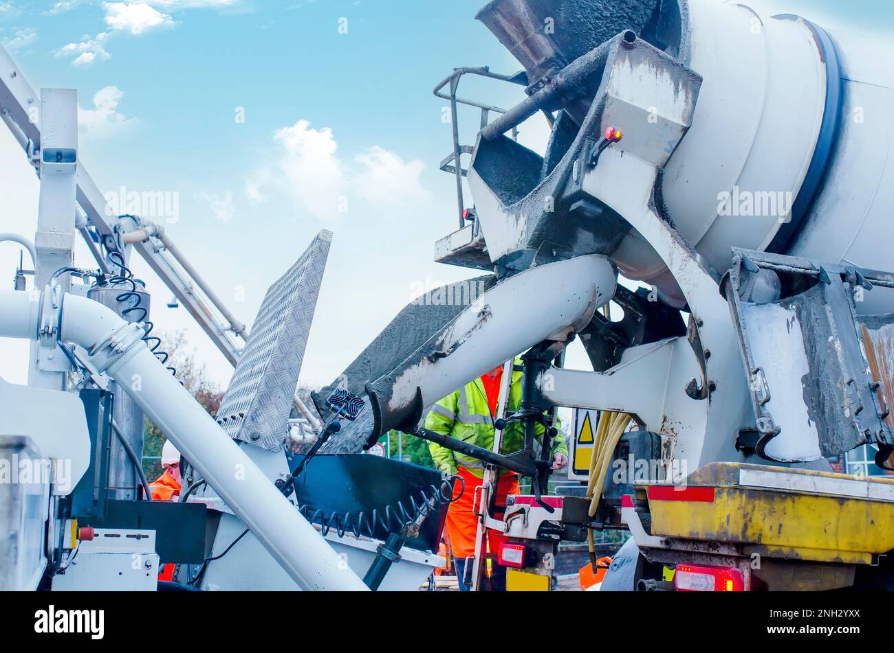 Concrete is offloaded from a concrete mixer into a concrete pump ...