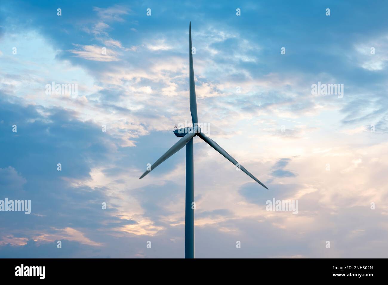 An electricity generating windmills on the yellow and green field ...