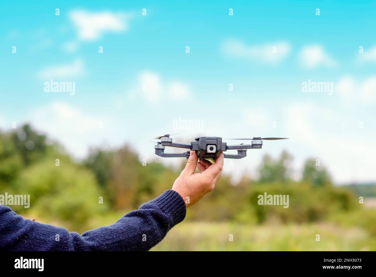 man using a drone with remote controller making photos and videos ...