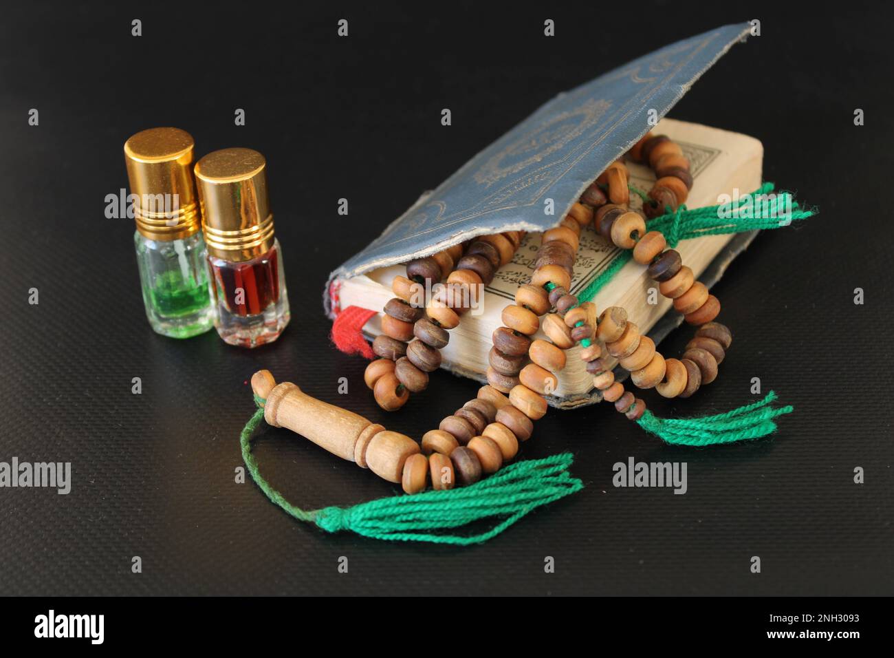Islamic concept on black background. Dark brown prayer rosary beads and ...