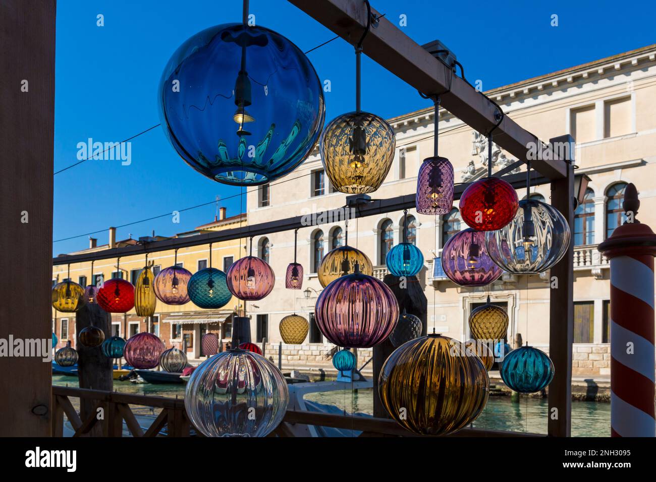 Murano glass lights with reflections hanging opposite Museo del Vetro Murano Glass Museum at ...