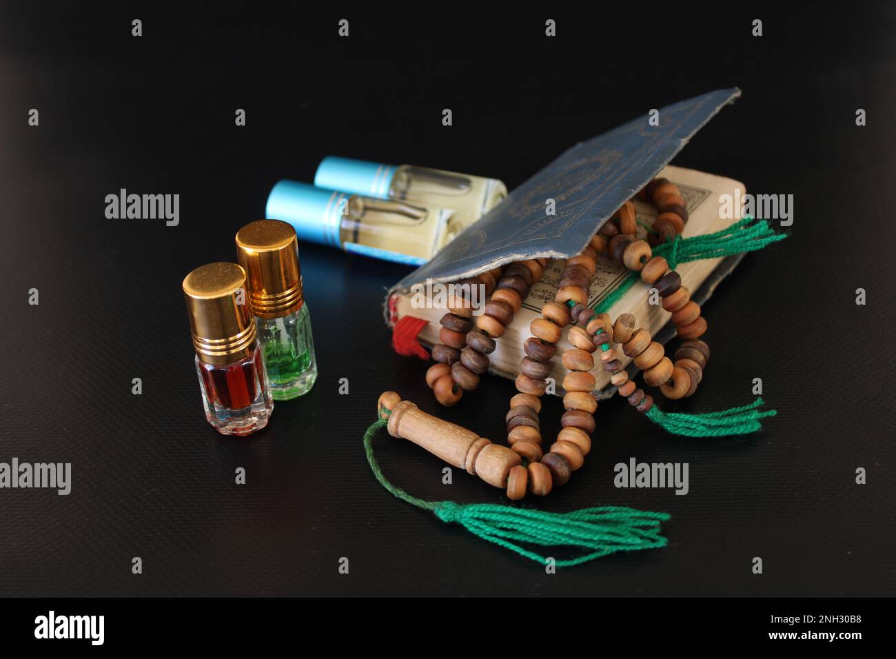 Islamic concept on black background. Dark brown prayer rosary beads and ...