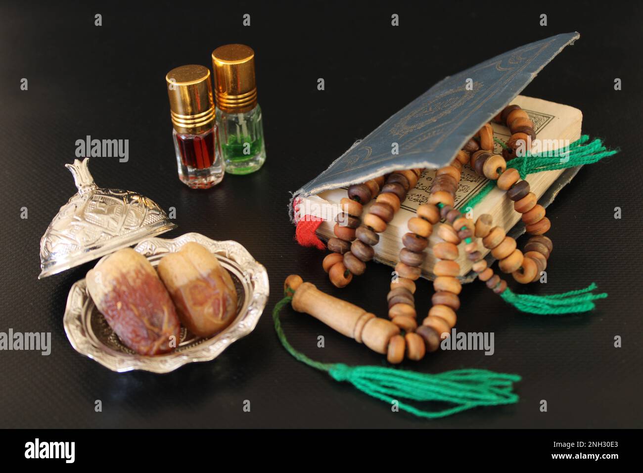 Islamic concept on black background. Dark brown prayer rosary beads and ...