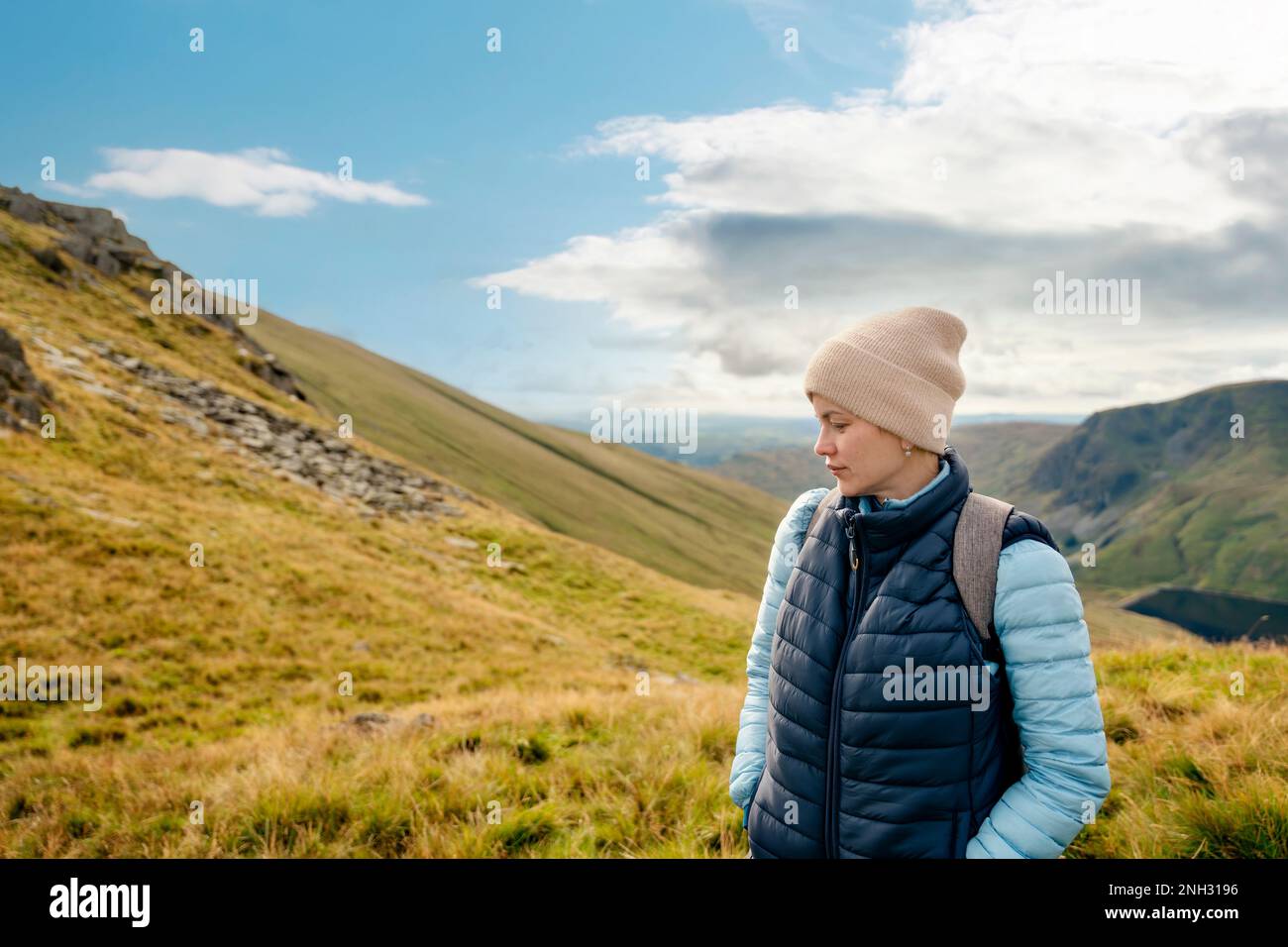 Woman reaching the destination and on the top of mountain against ...
