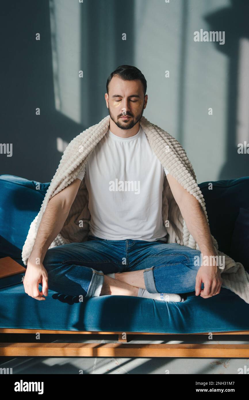 Calm relaxed caucasian man, sitting alone at home in living room on a ...