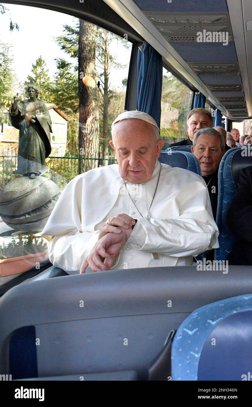 Pope Francis looks at his watch during as he travels to the 'Casa del ...