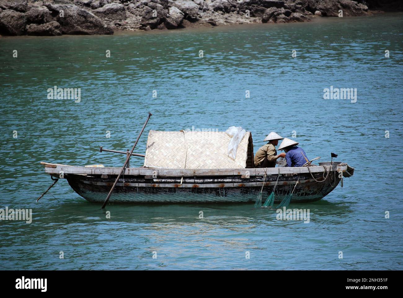 Vietnamese fishermen in Ha Long Bay. They live in floating villages in ...